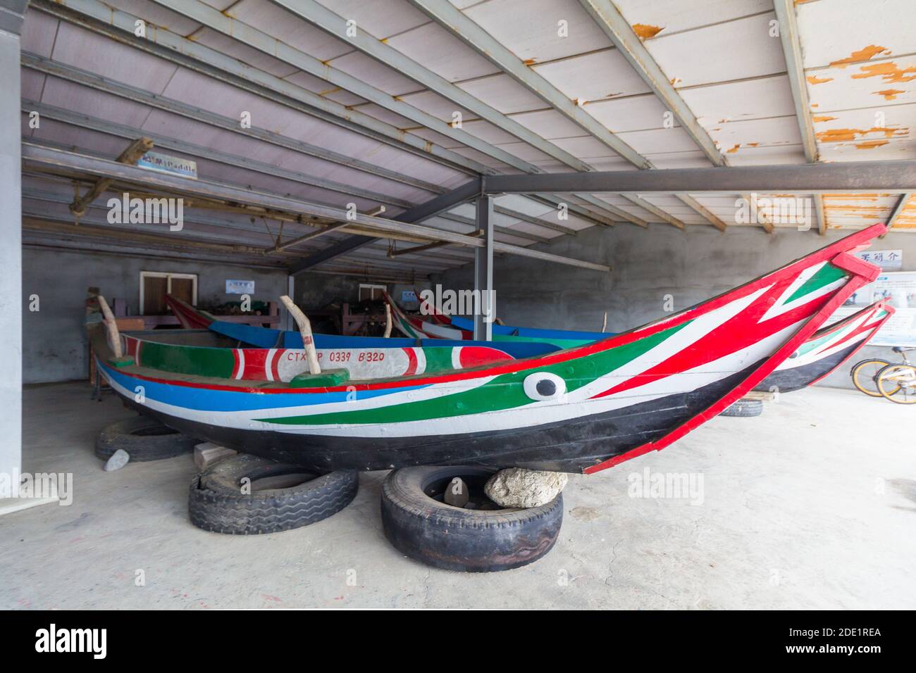 Painted local boat stored at a garage in Taipei, Taiwan Stock Photo - Alamy