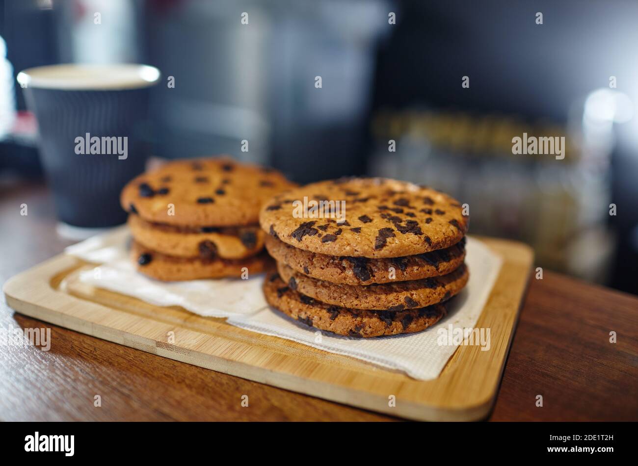 Tasty cookie at bar counter in coffee shop. Blurred image, selective ...