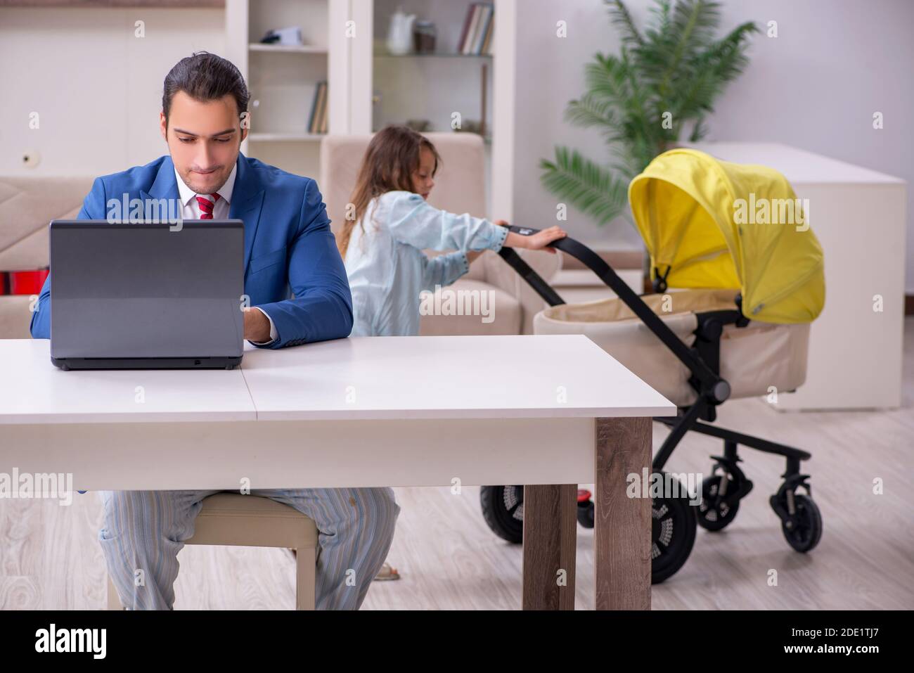 Young father of two children working from house Stock Photo - Alamy