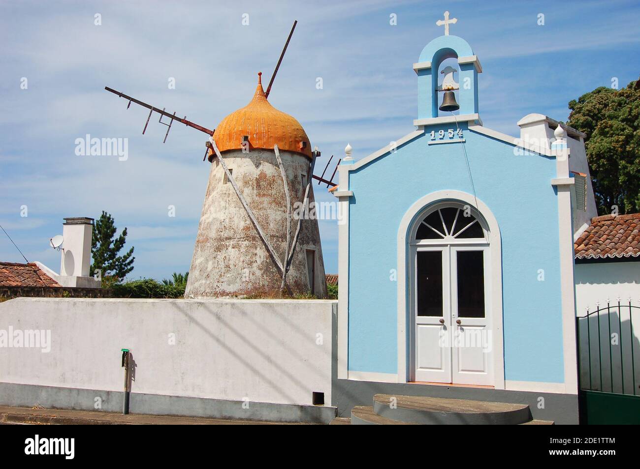 Red windmill and church in azores island Stock Photo - Alamy