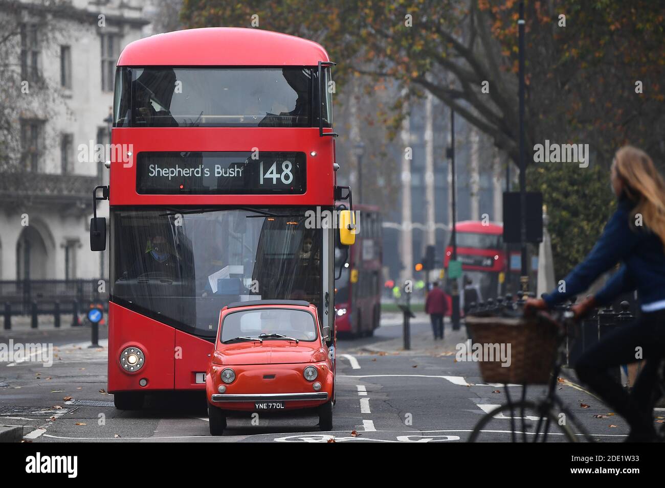 A classic Fiat 500 is followed through central London by a double ...