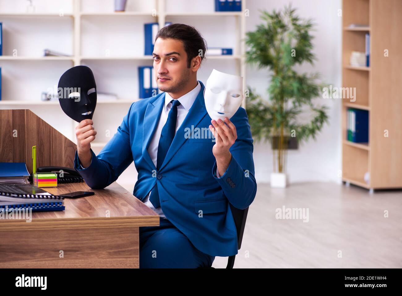 Young employee wearing mask in the office Stock Photo - Alamy