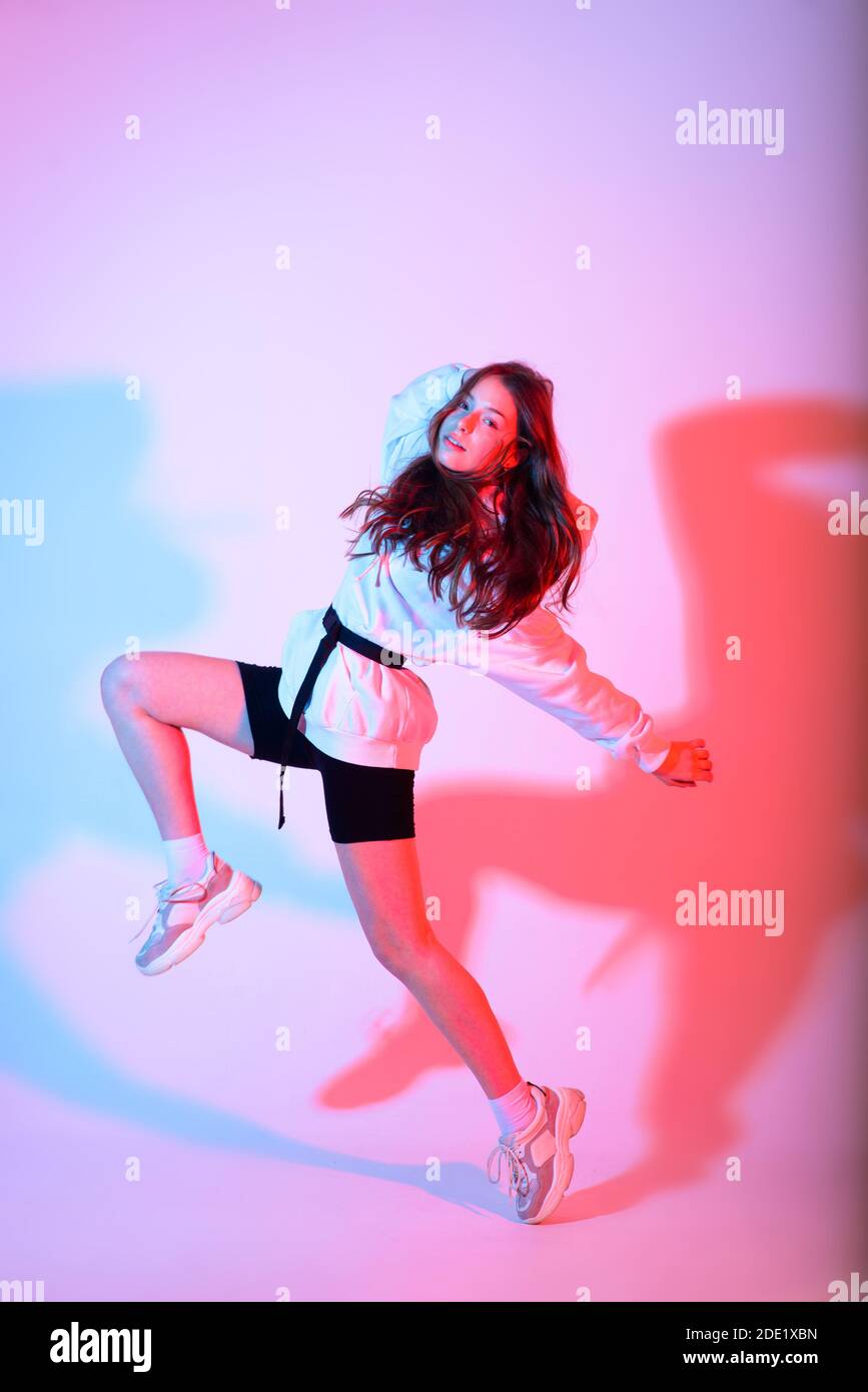 Young beautiful dancer posing on studio background Stock Photo - Alamy
