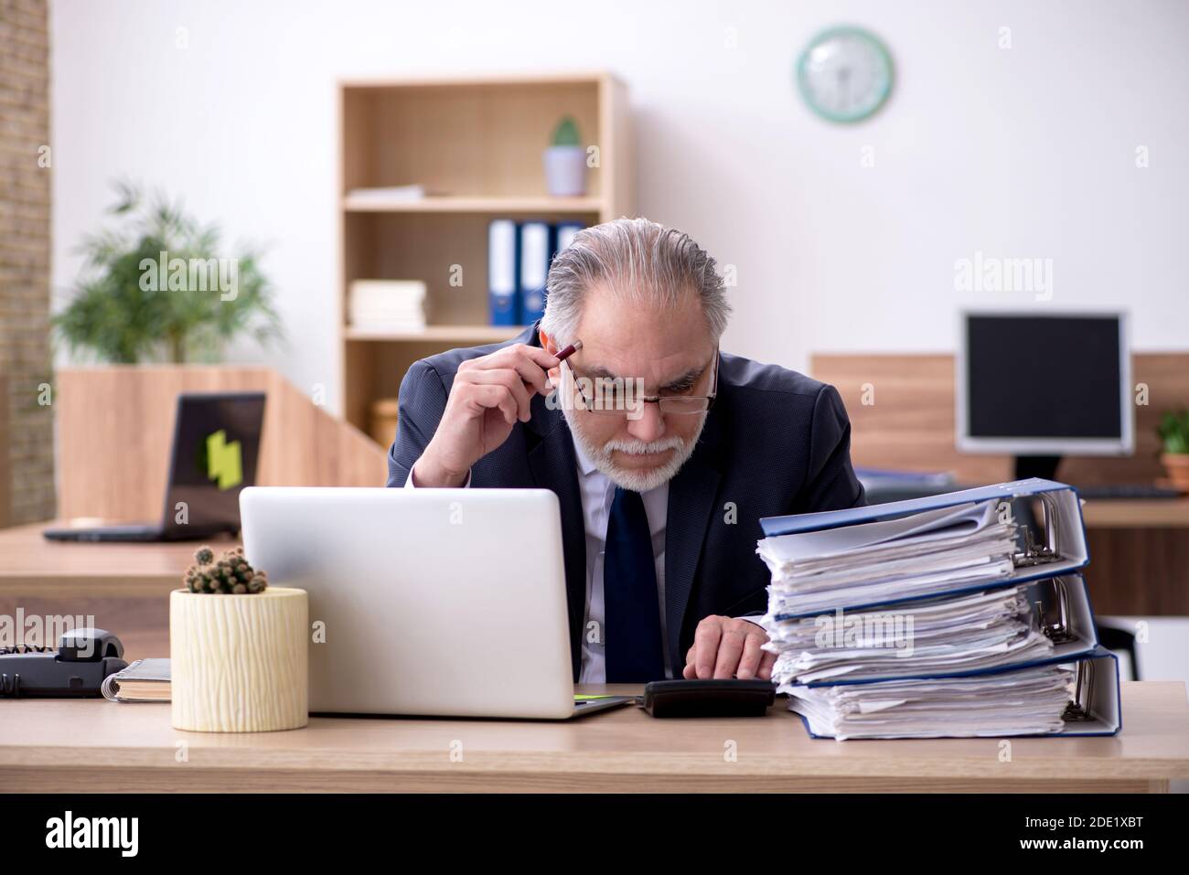Old employee working in the office Stock Photo - Alamy