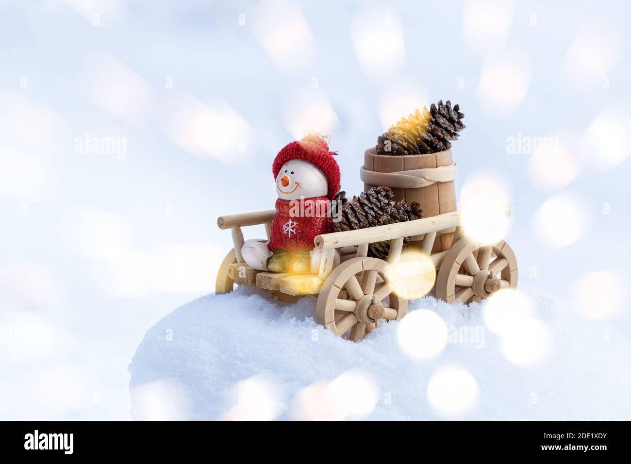 Festive Christmas background with snowman on a wooden cart. Happy ...