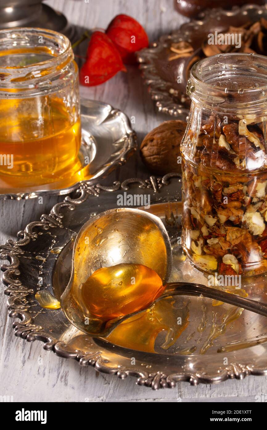 Cooking a delicious dessert - walnuts in honey. A jar filled with nuts ...