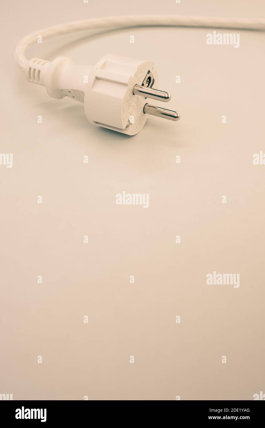 A vertical shot of an electrical plug and wire on a white surface Stock ...