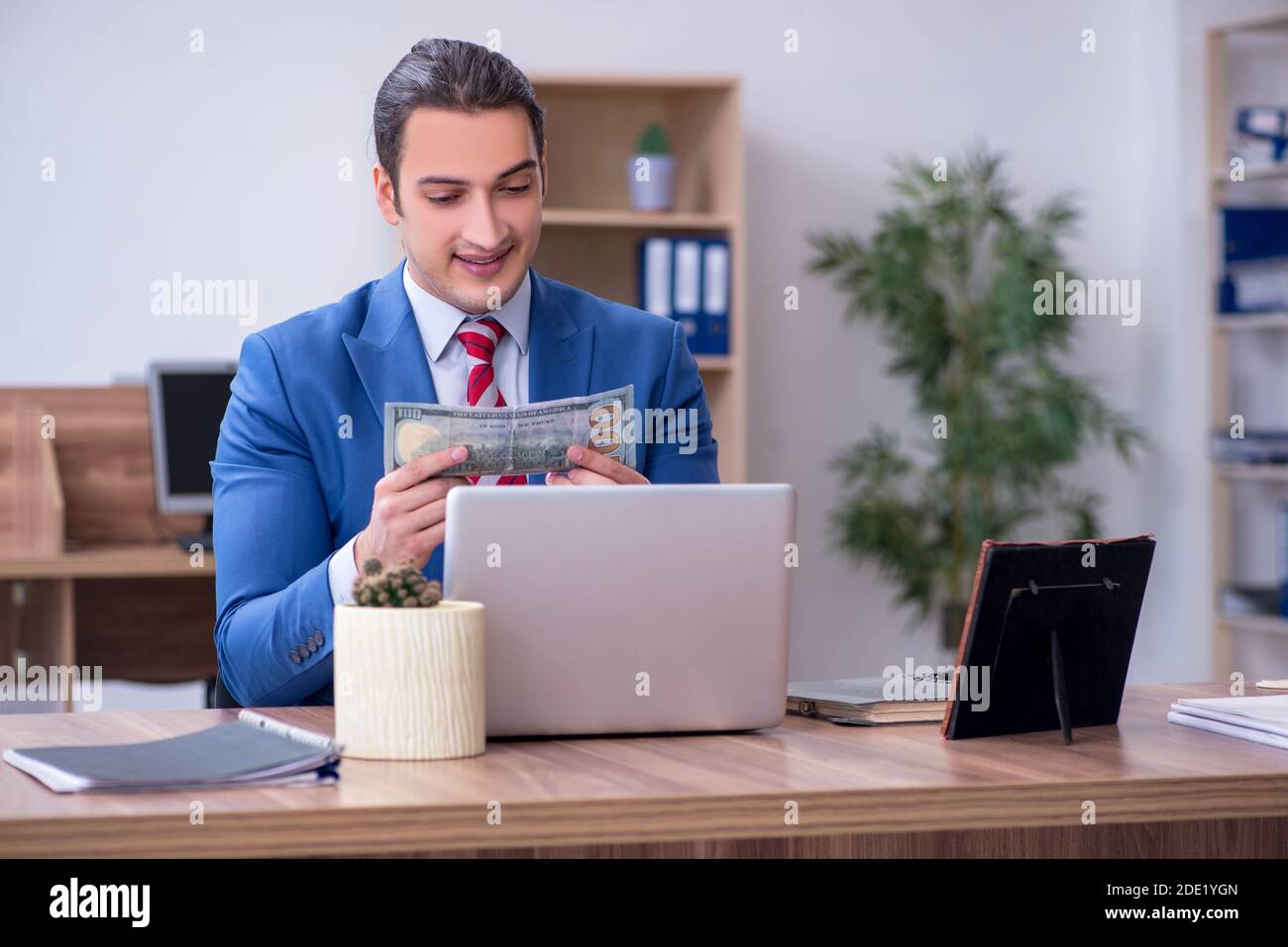 Young employee in salary increase concept Stock Photo - Alamy