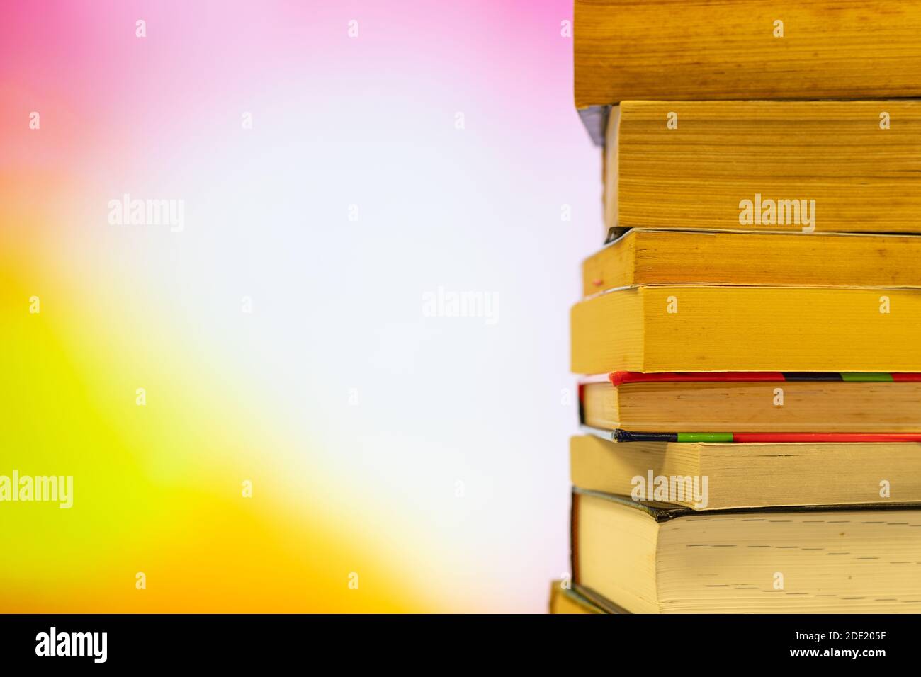 A pile of books with blurred colourful background for copy space Stock ...