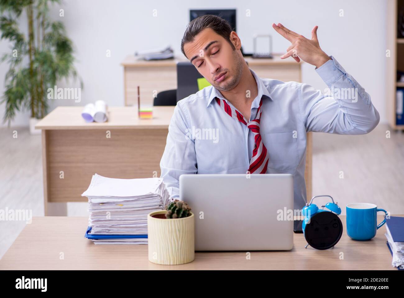 Male employee in time management concept Stock Photo - Alamy