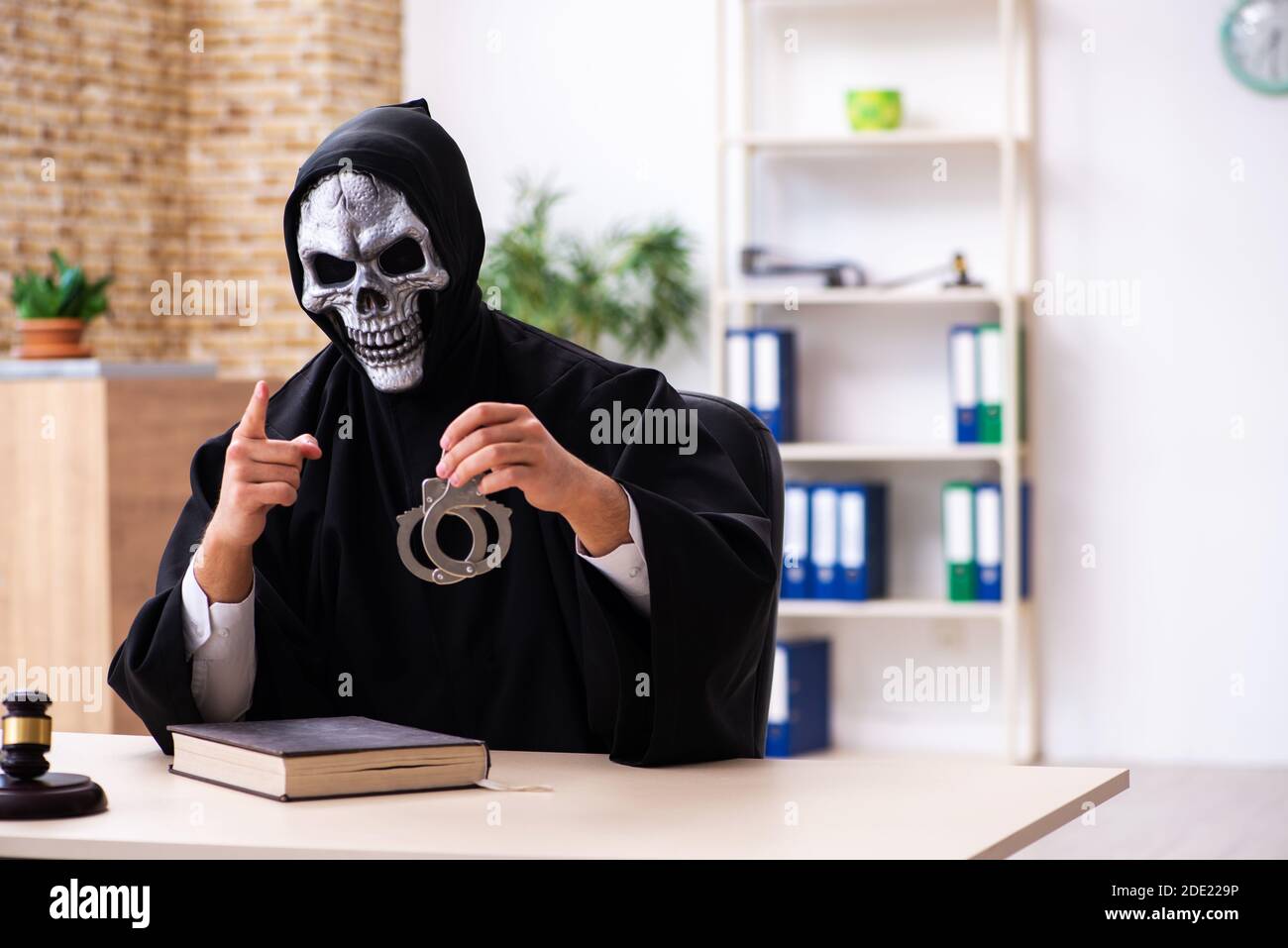 Devil judge working in the courthouse Stock Photo - Alamy