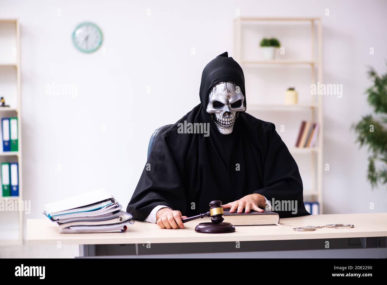 Devil judge working in the courthouse Stock Photo - Alamy
