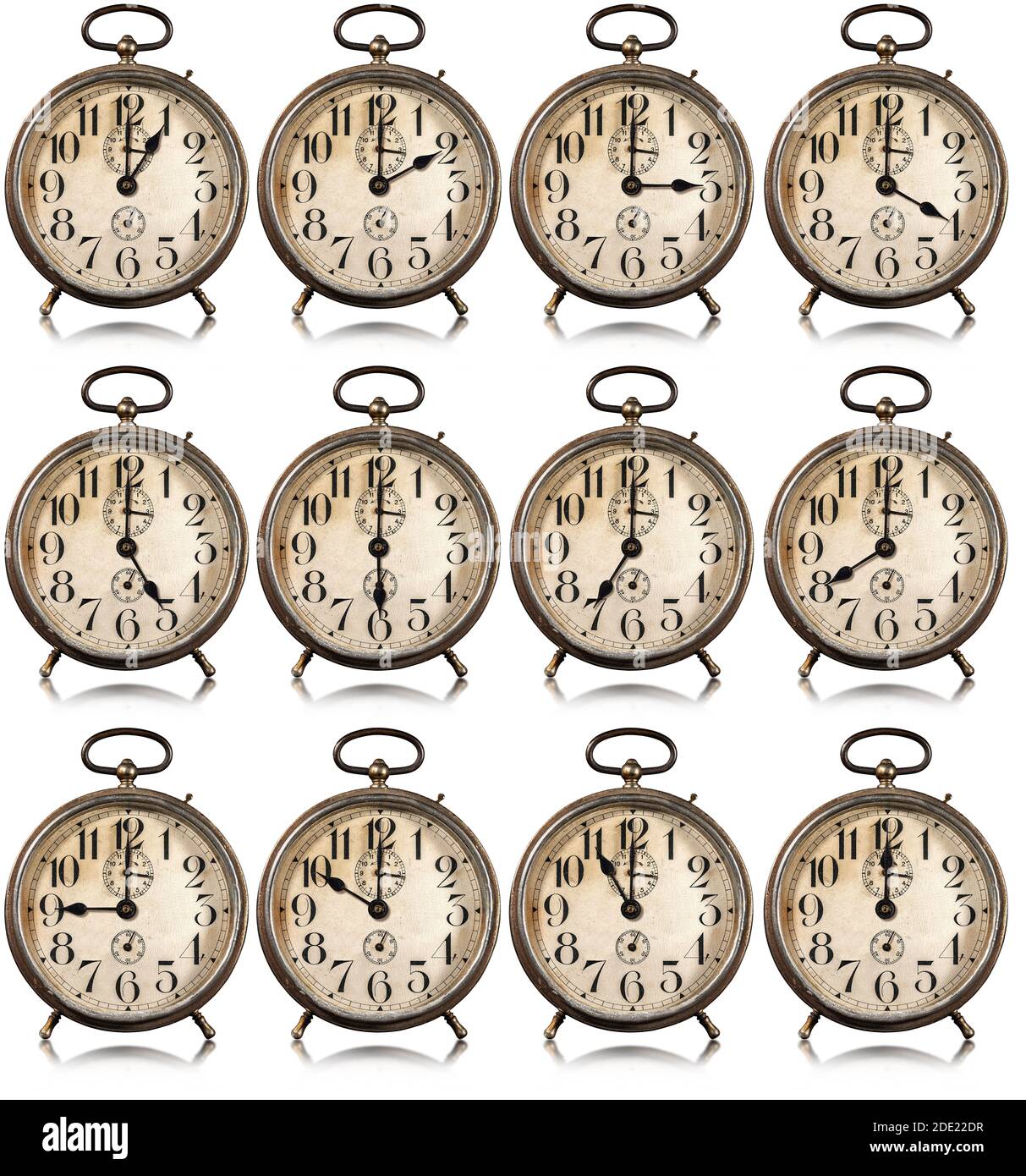 Collection of twelve old alarm clocks with all hours of the day ...