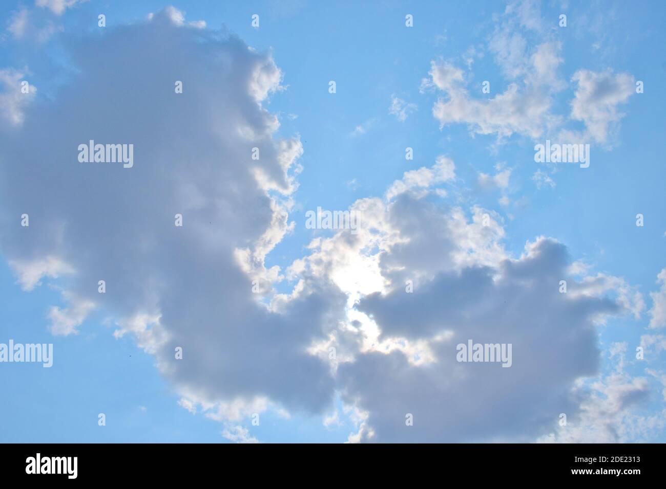 The sky with beautiful fluffy clouds, behind which the sun hid Stock ...