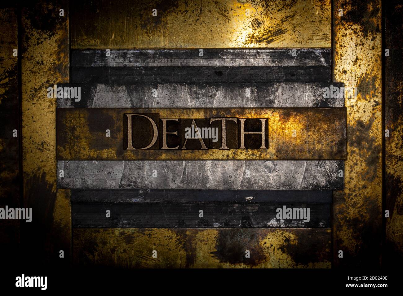 Death text on lead bar over textured grunge copper and vintage gold ...