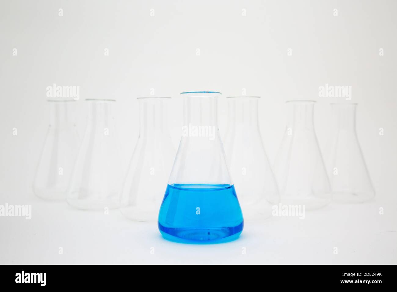 Scientific laboratory glass erlenmeyer flask filled with blue liquid ...