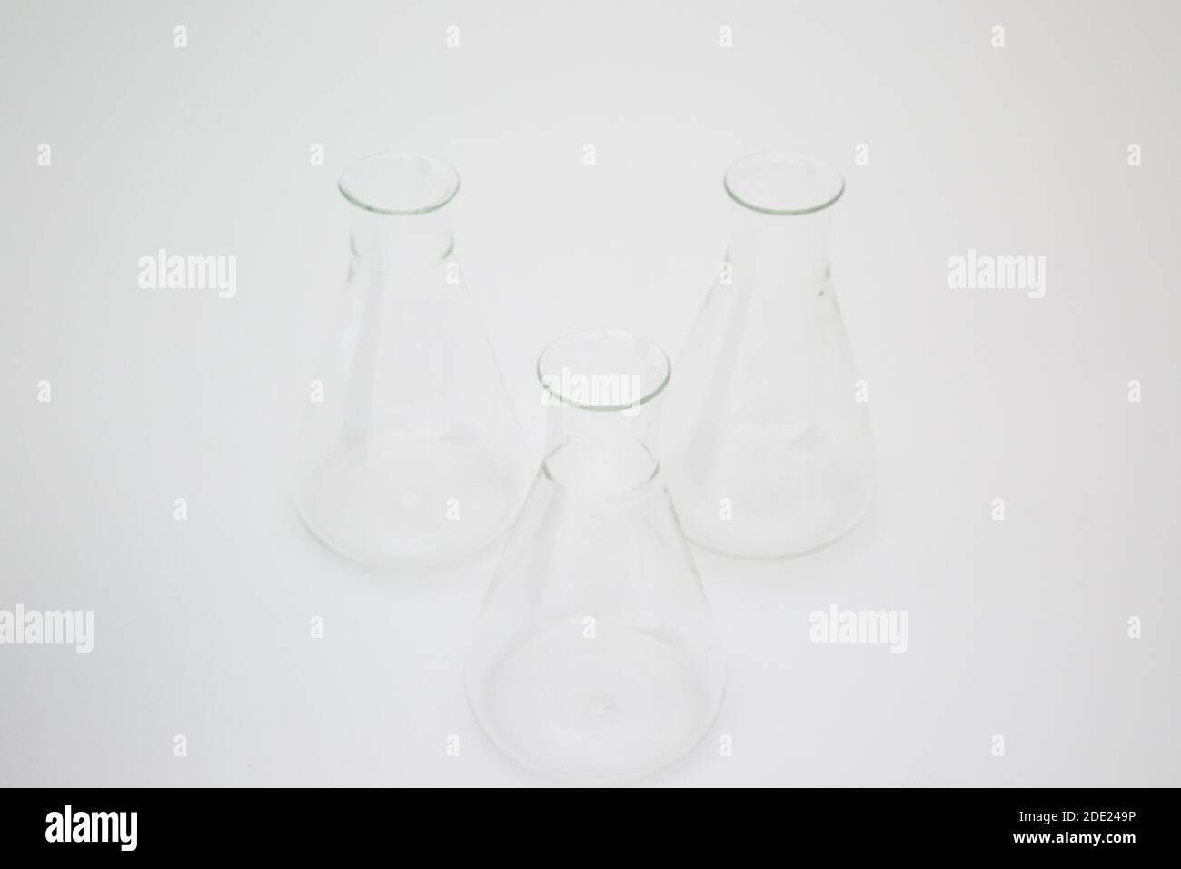 Three scientific laboratory glass erlenmeyer flask isolated on white ...