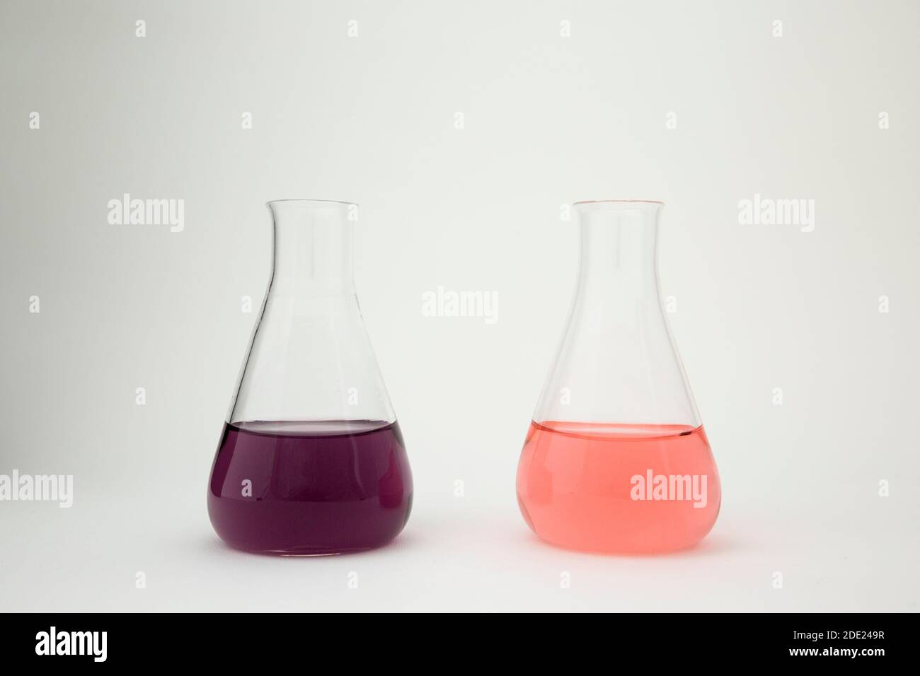 Scientific laboratory glass erlenmeyer flask filled with purple and ...