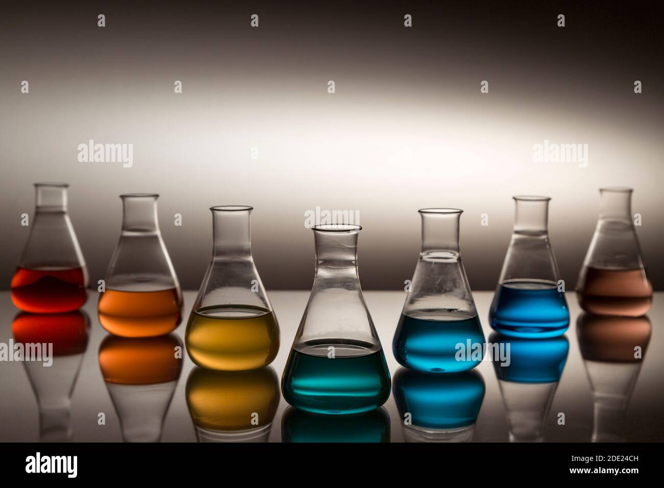 Scientific laboratory glass erlenmeyer flask filled with colorful ...