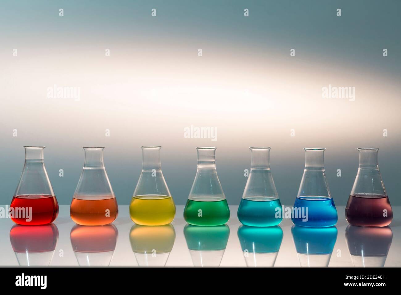 Scientific laboratory glass erlenmeyer flask filled with colorful ...
