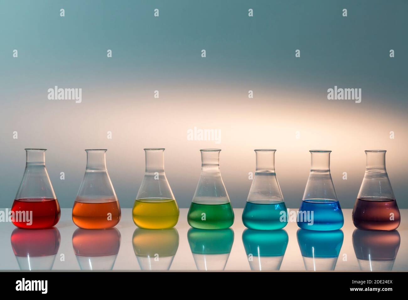 Scientific laboratory glass erlenmeyer flask filled with colorful ...
