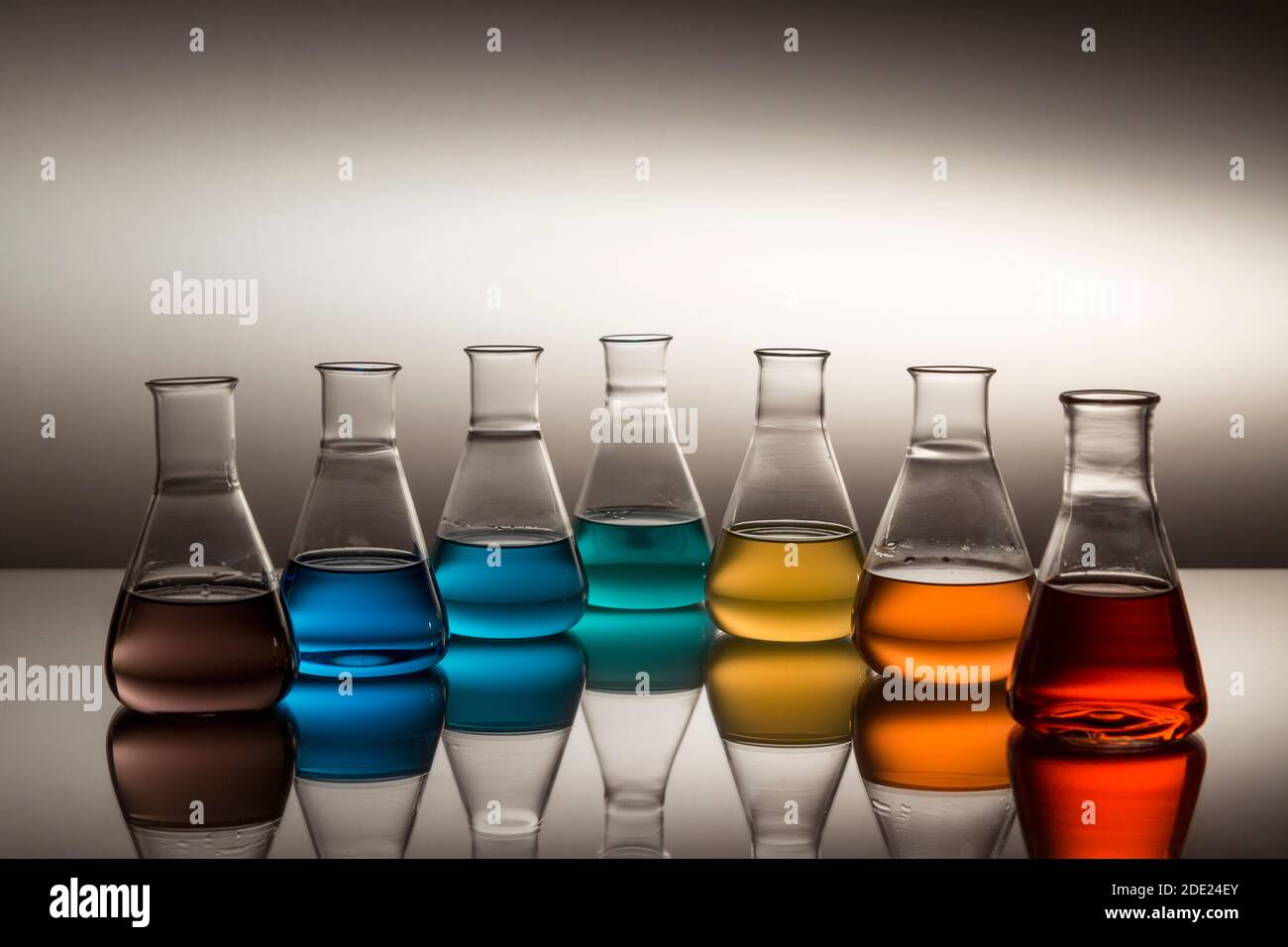 Scientific laboratory glass erlenmeyer flask filled with colorful ...