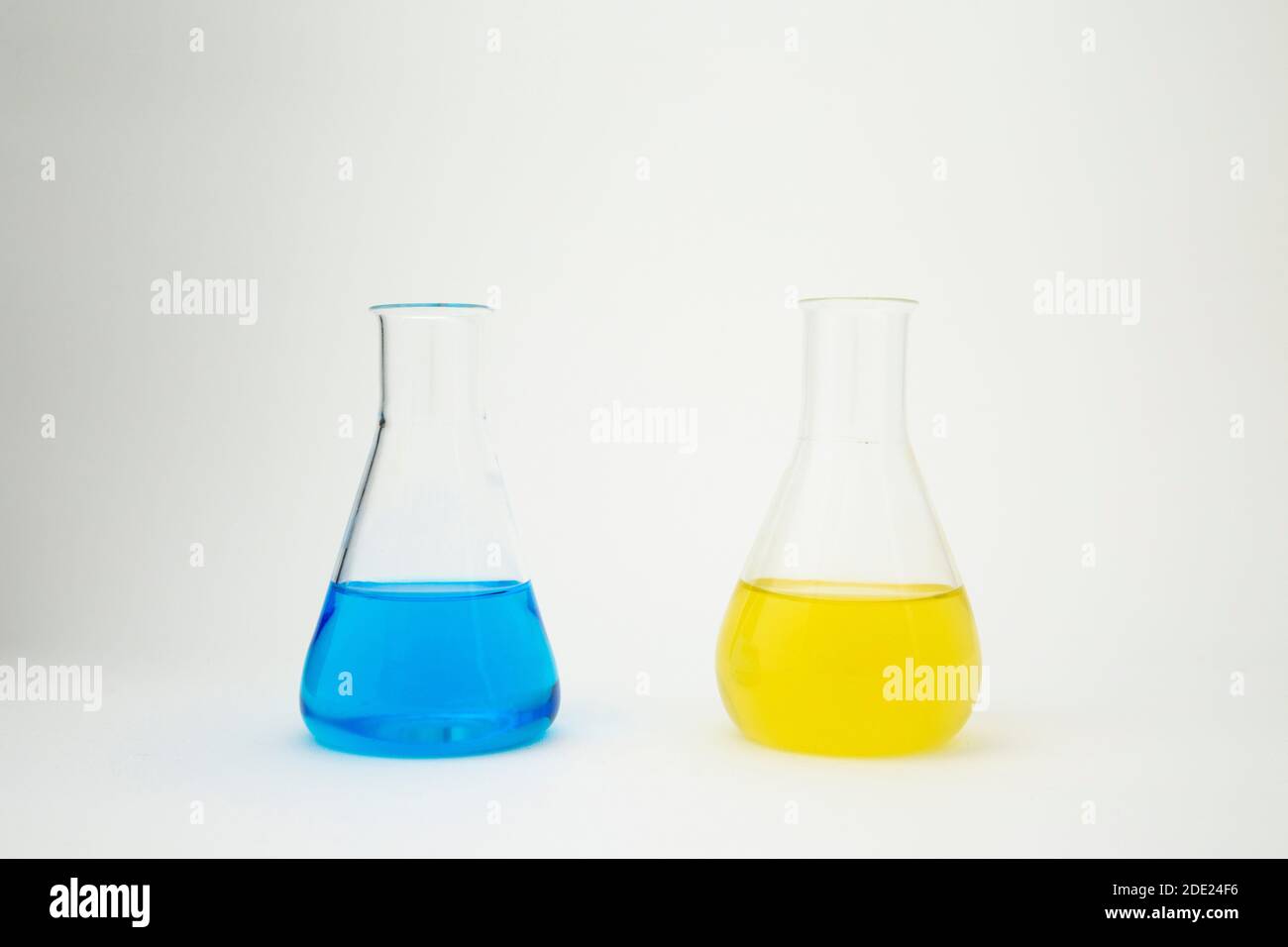 Scientific laboratory glass erlenmeyer flask filled with blue and ...