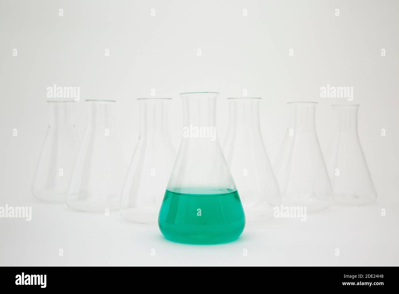 Scientific laboratory glass erlenmeyer flask filled with green liquid ...