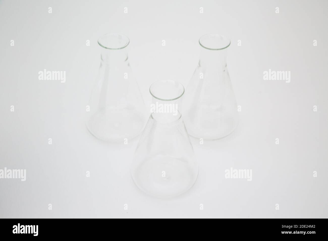Three scientific laboratory glass erlenmeyer flask isolated on white ...