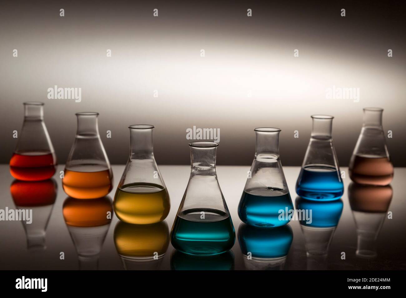 Scientific laboratory glass erlenmeyer flask filled with colorful ...