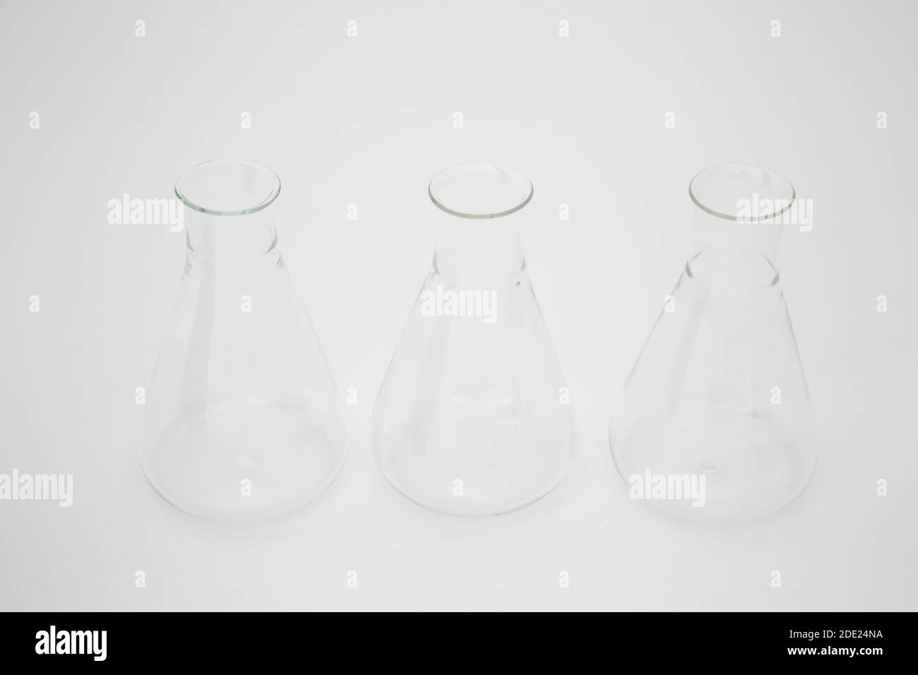 Three scientific laboratory glass erlenmeyer flask isolated on white ...