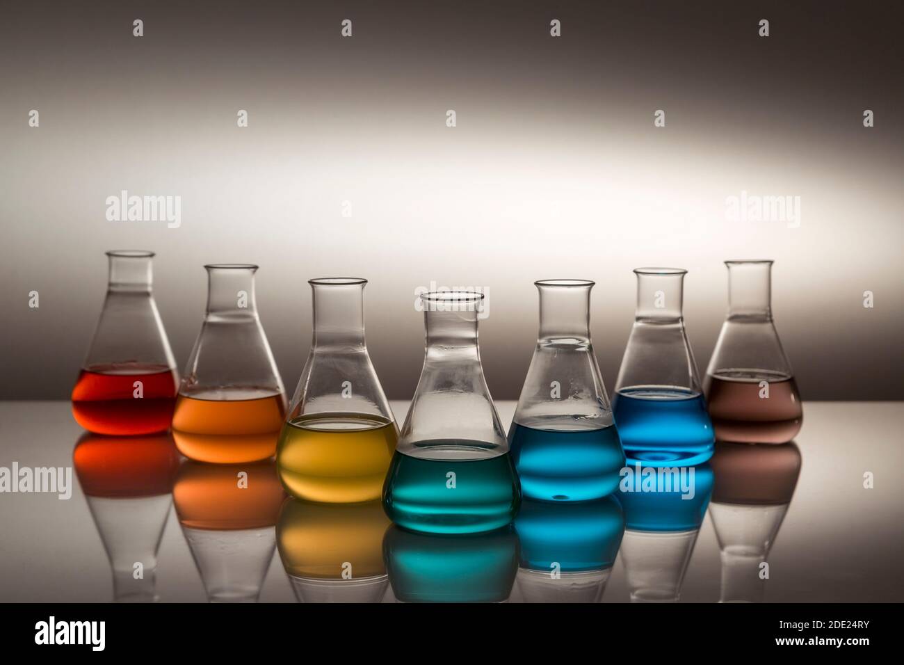 Scientific laboratory glass erlenmeyer flask filled with colorful ...