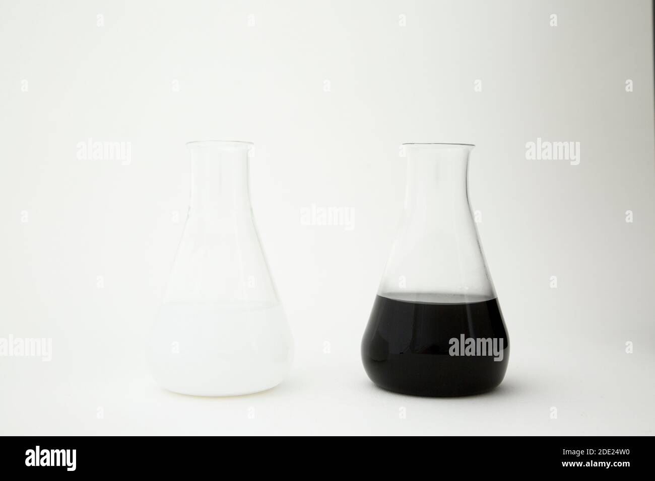 Scientific laboratory glass erlenmeyer flask filled with white and ...