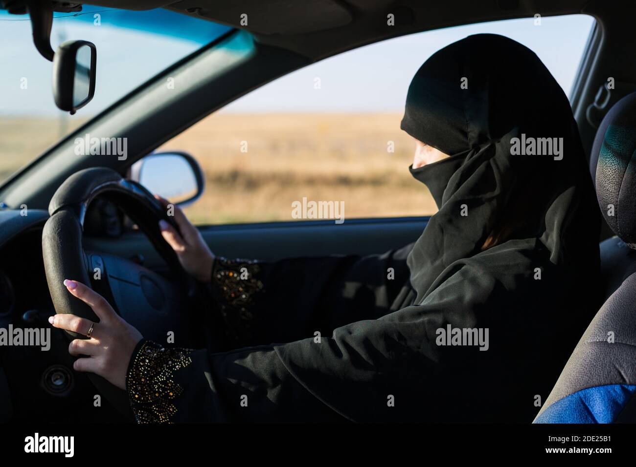 Serious islamic woman driver looking at road Stock Photo - Alamy