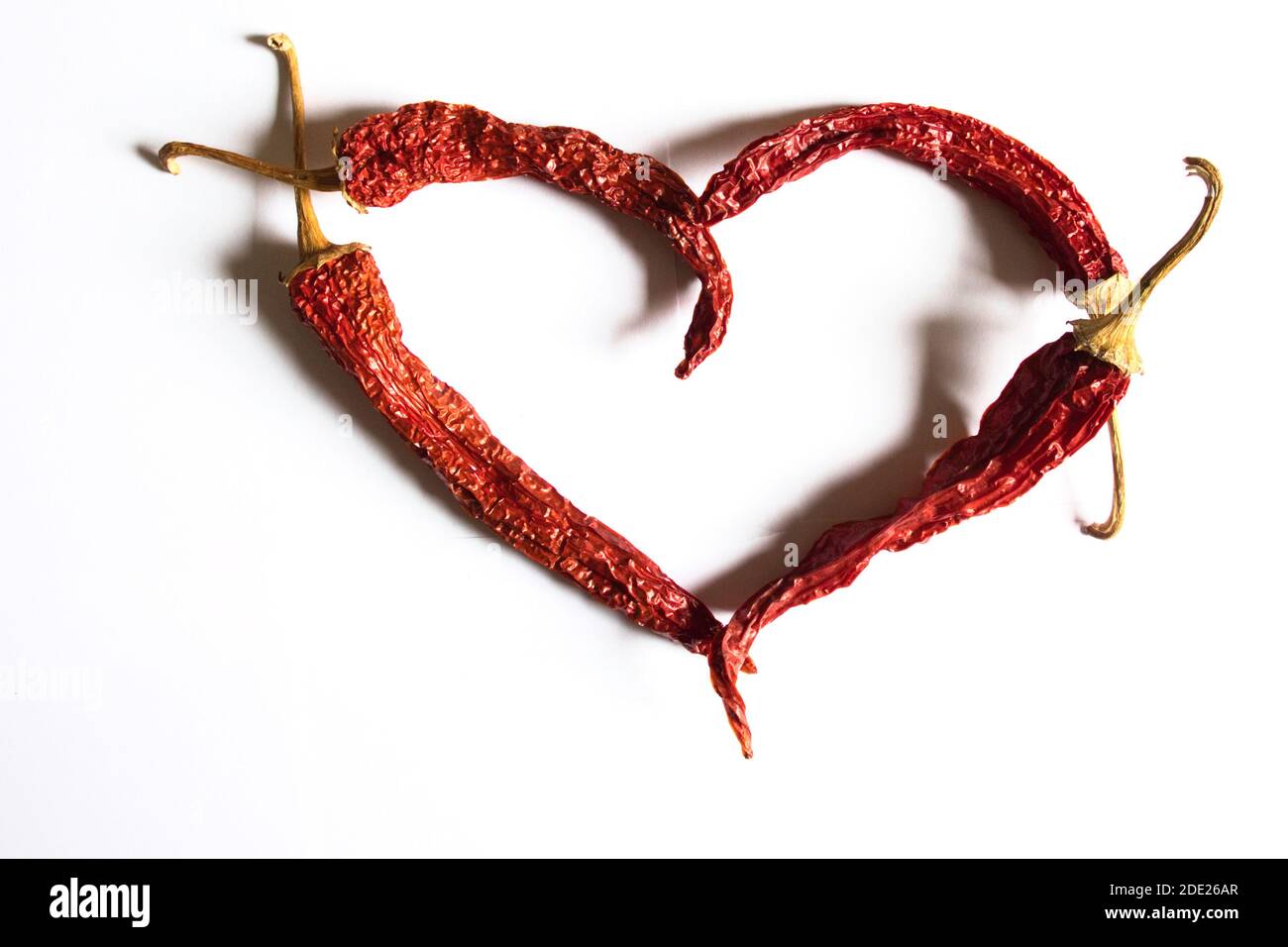 Red heart composed of red chili peppers on white background. Symbol of ...