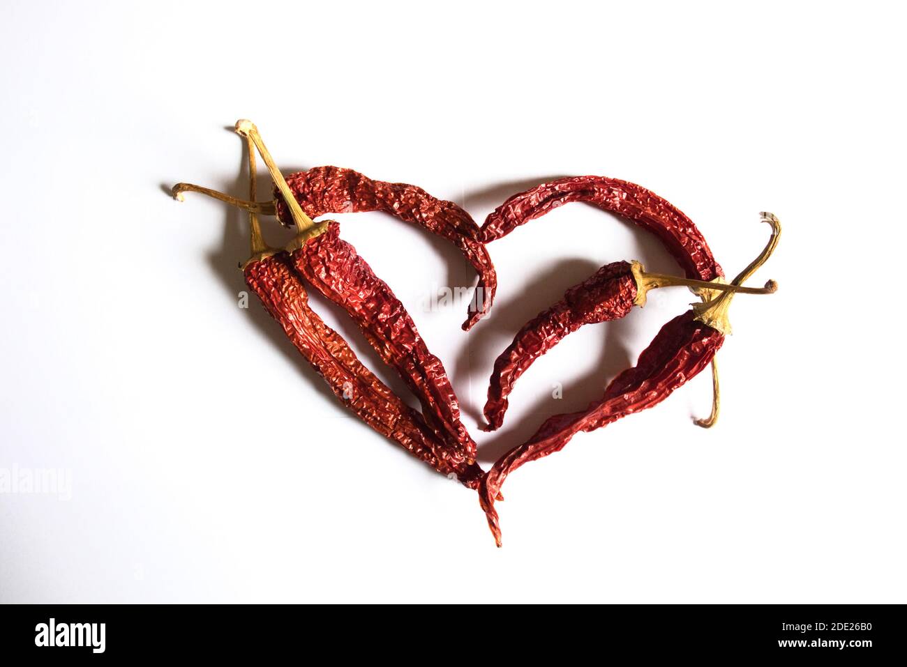 Red heart composed of red chili peppers on white background. Symbol of ...