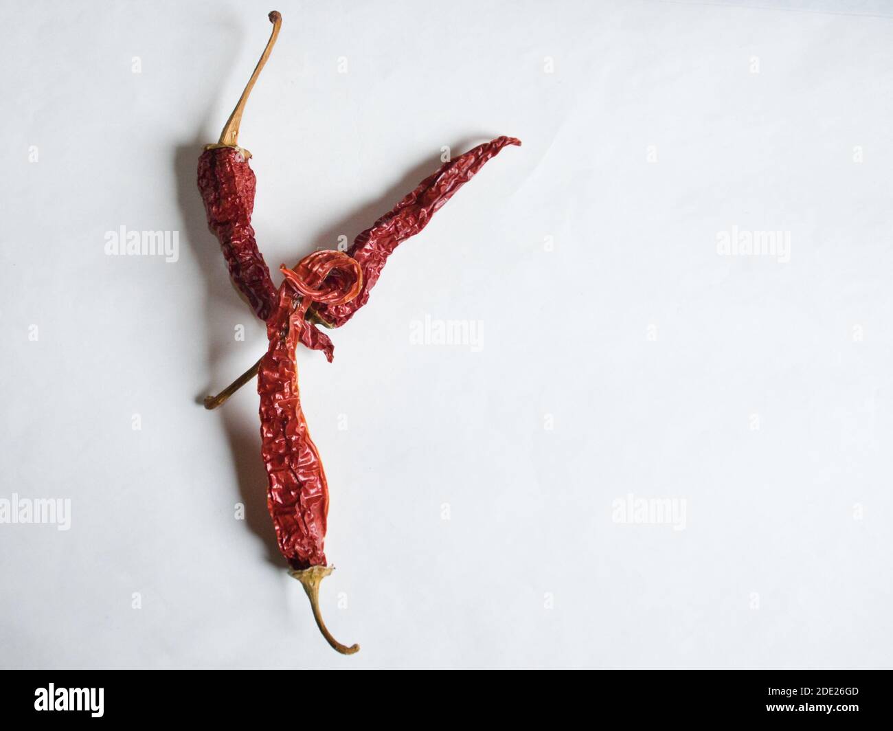 Letter Y lined with red peppers on a white background. Symbol in the ...