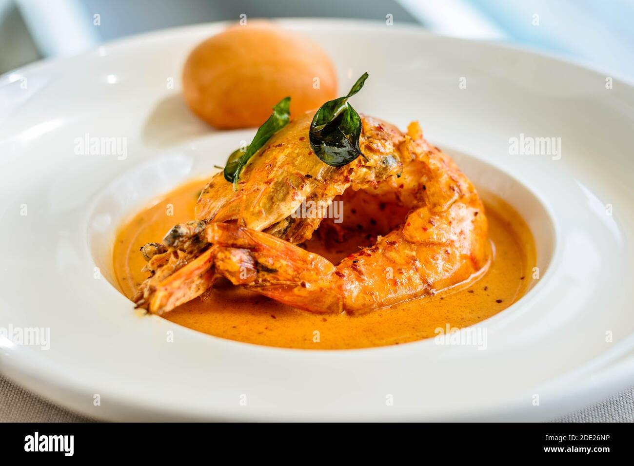 main course of King Prawn served in Bang Sauce with a bun Stock Photo ...