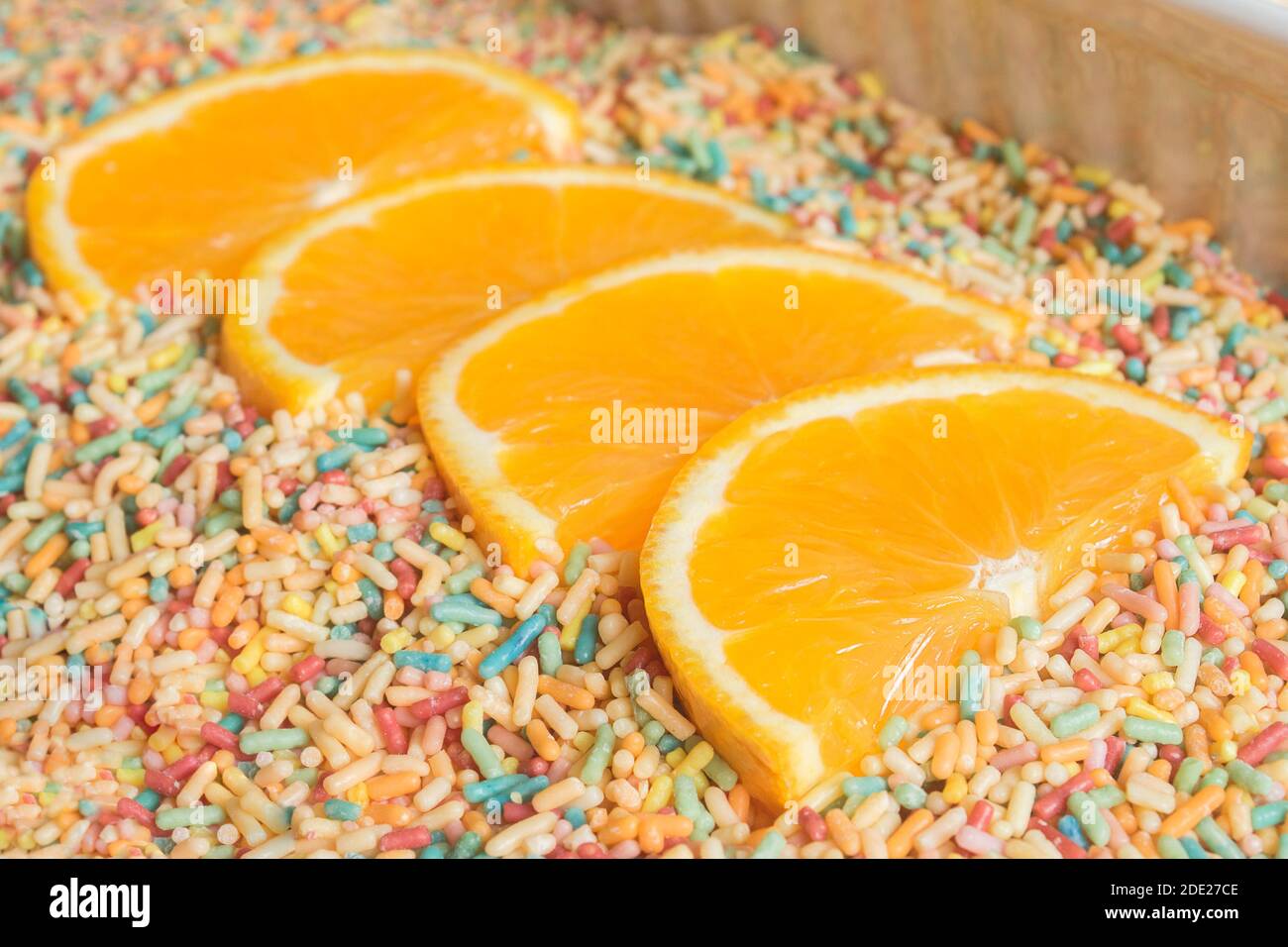 Orange slices on a candy pass. Fruit cake and sweets with colored sugar ...