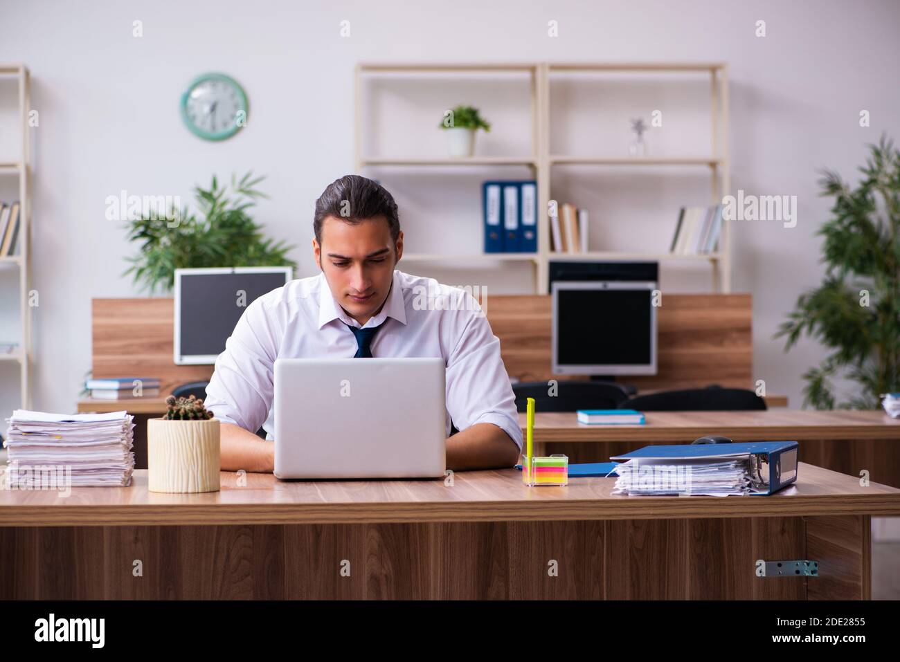 Young employee working in the office Stock Photo - Alamy