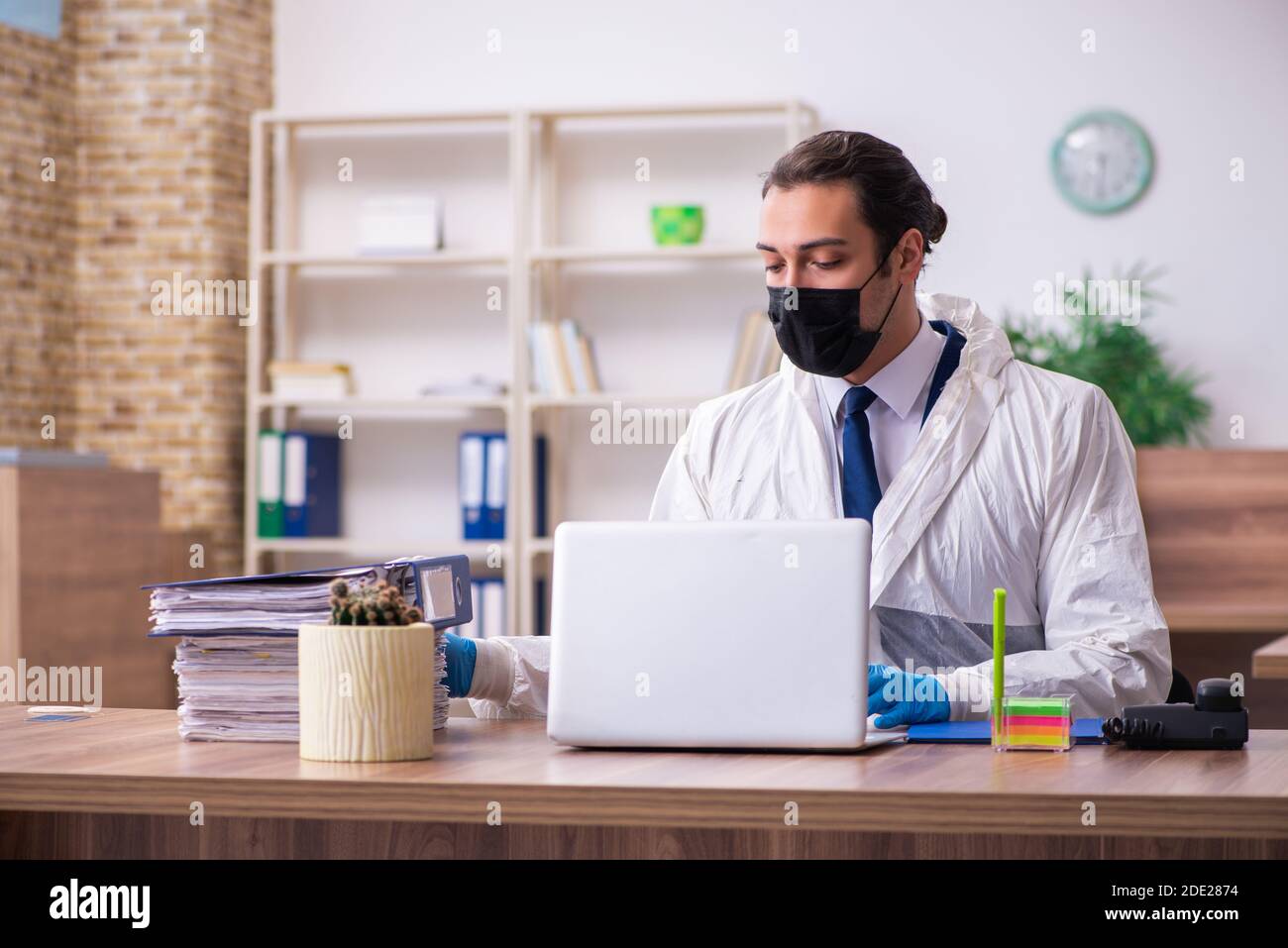 Young male employee in the self-isolation concept Stock Photo - Alamy