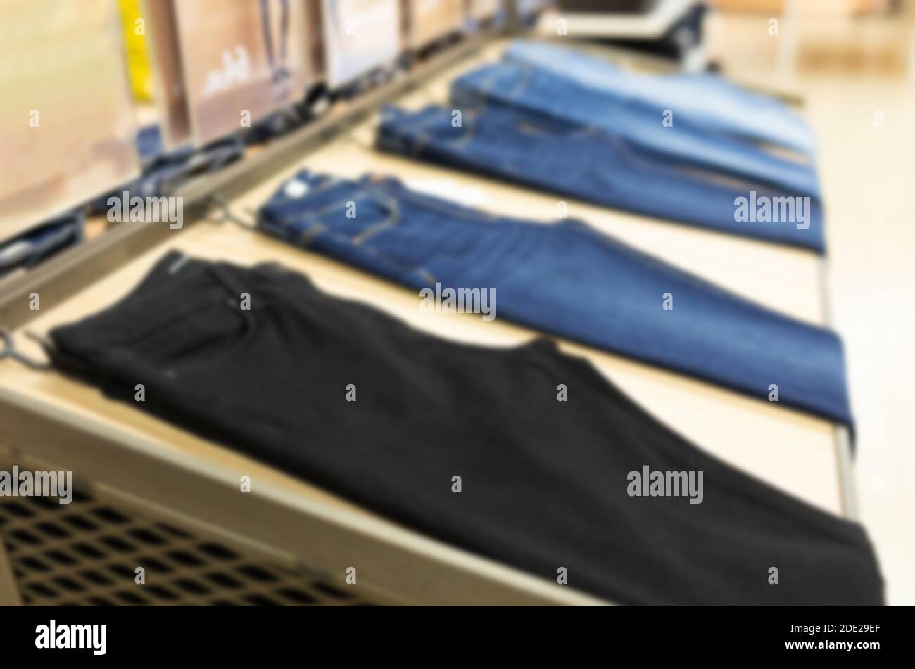 clothing store with a large assortment of pants and jeans hanging on ...