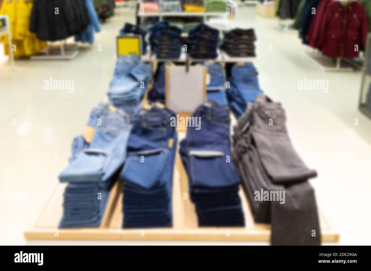 clothing store with a large assortment of pants and jeans hanging on ...