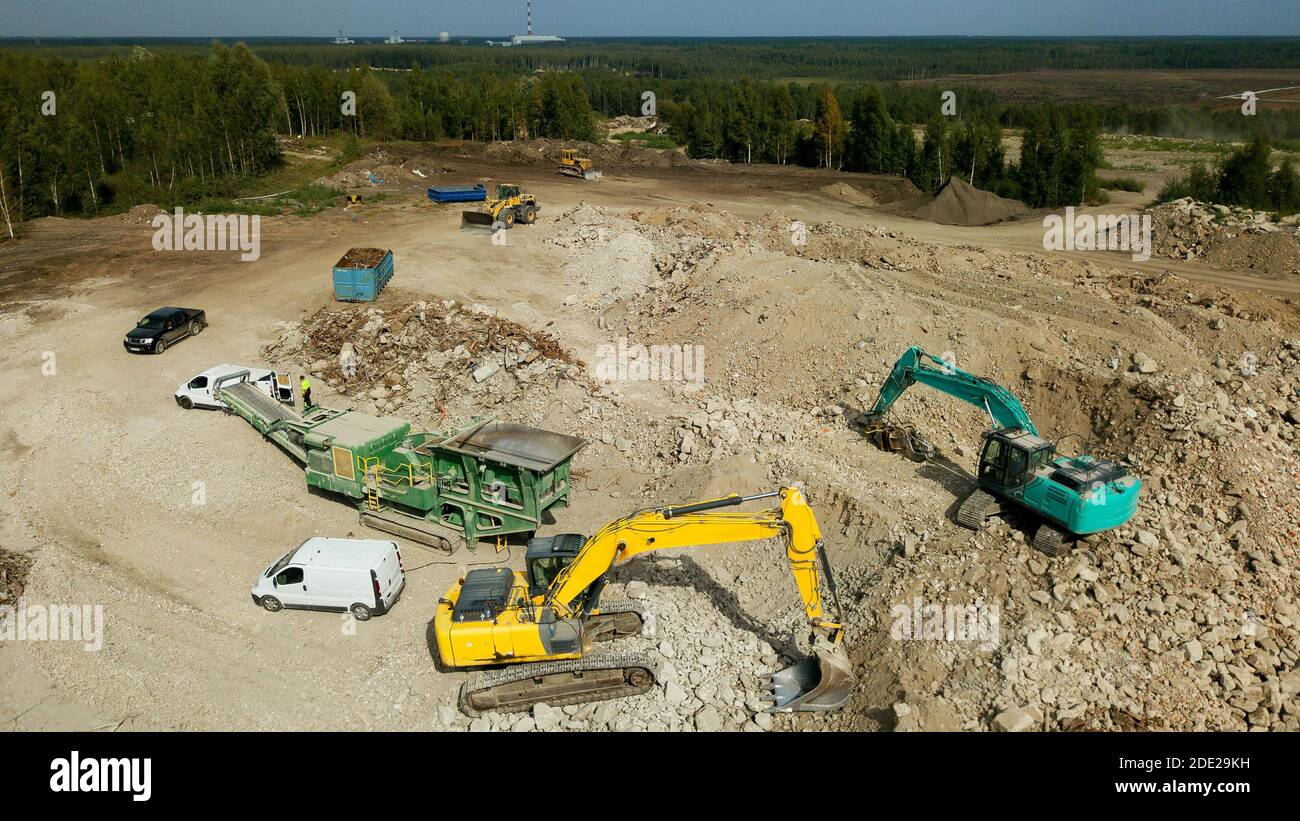 Aerial photo. Excavator at construction site near forest. Earthmoving ...