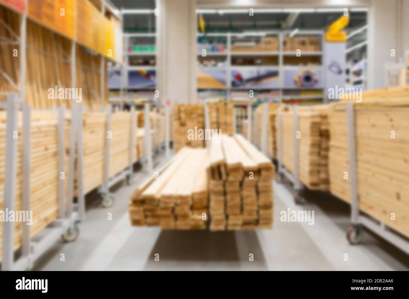 hardware store: shelving with large wooden boards, blurred and ...