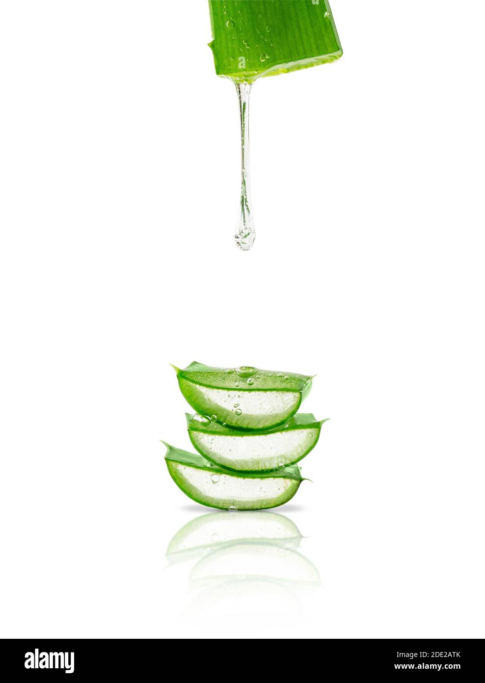 Aloe vera gel dripping over sliced leaves isolated on white background ...