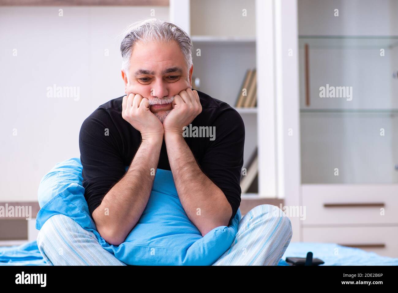 Old man in depression mode at home Stock Photo - Alamy