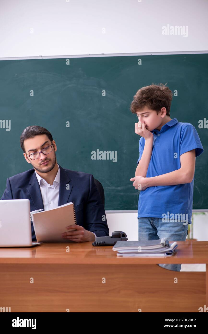Male teacher and schoolboy in the classroom Stock Photo - Alamy