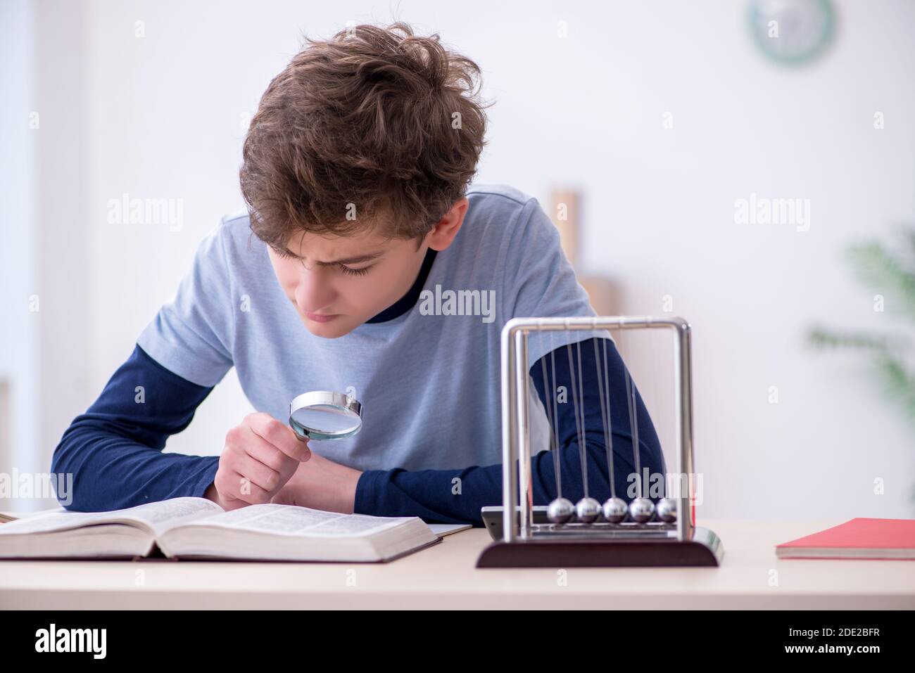 Boy studying physics at home Stock Photo - Alamy