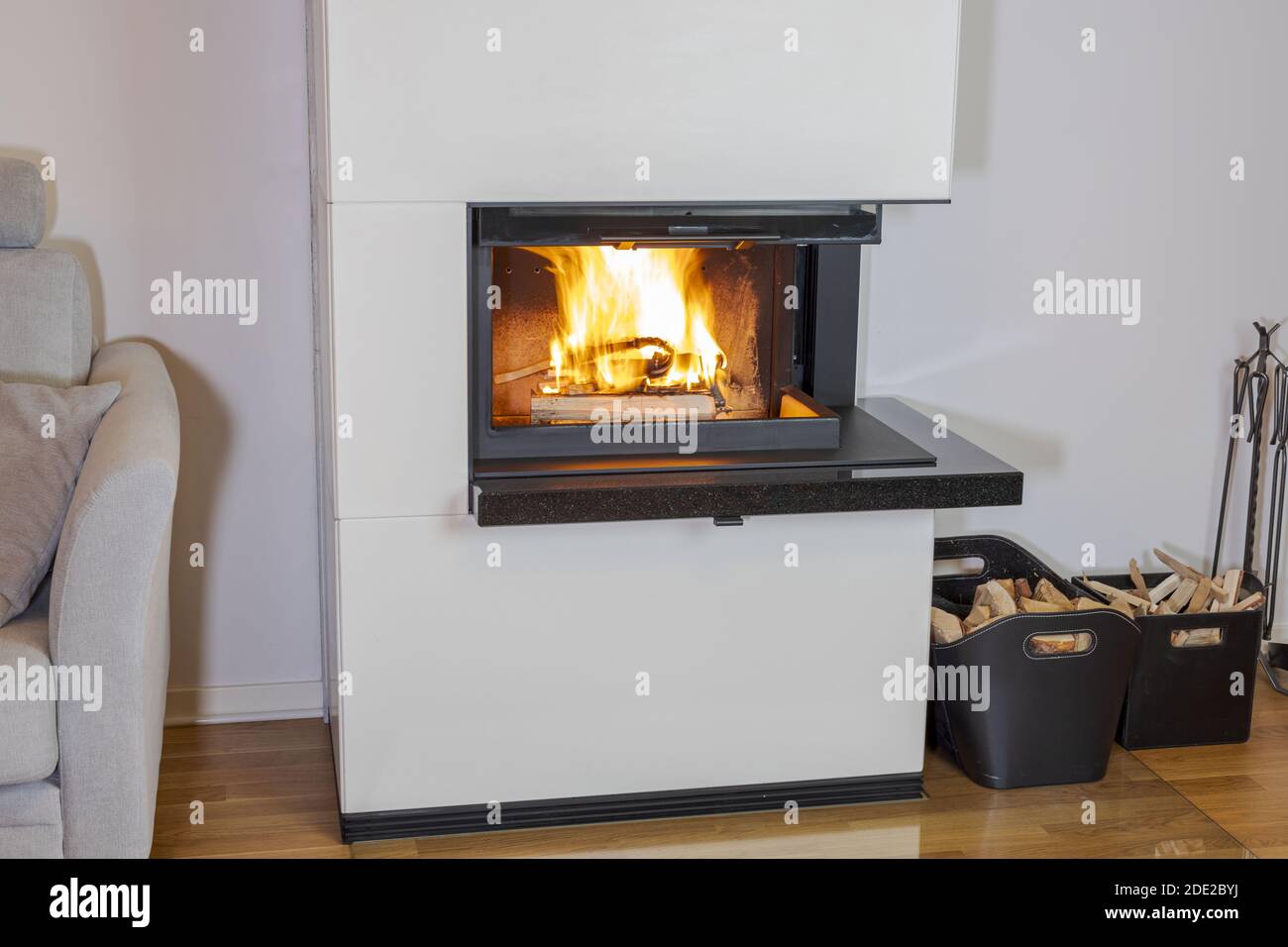 Beautiful view of interior of modern living room. View of burning wood ...